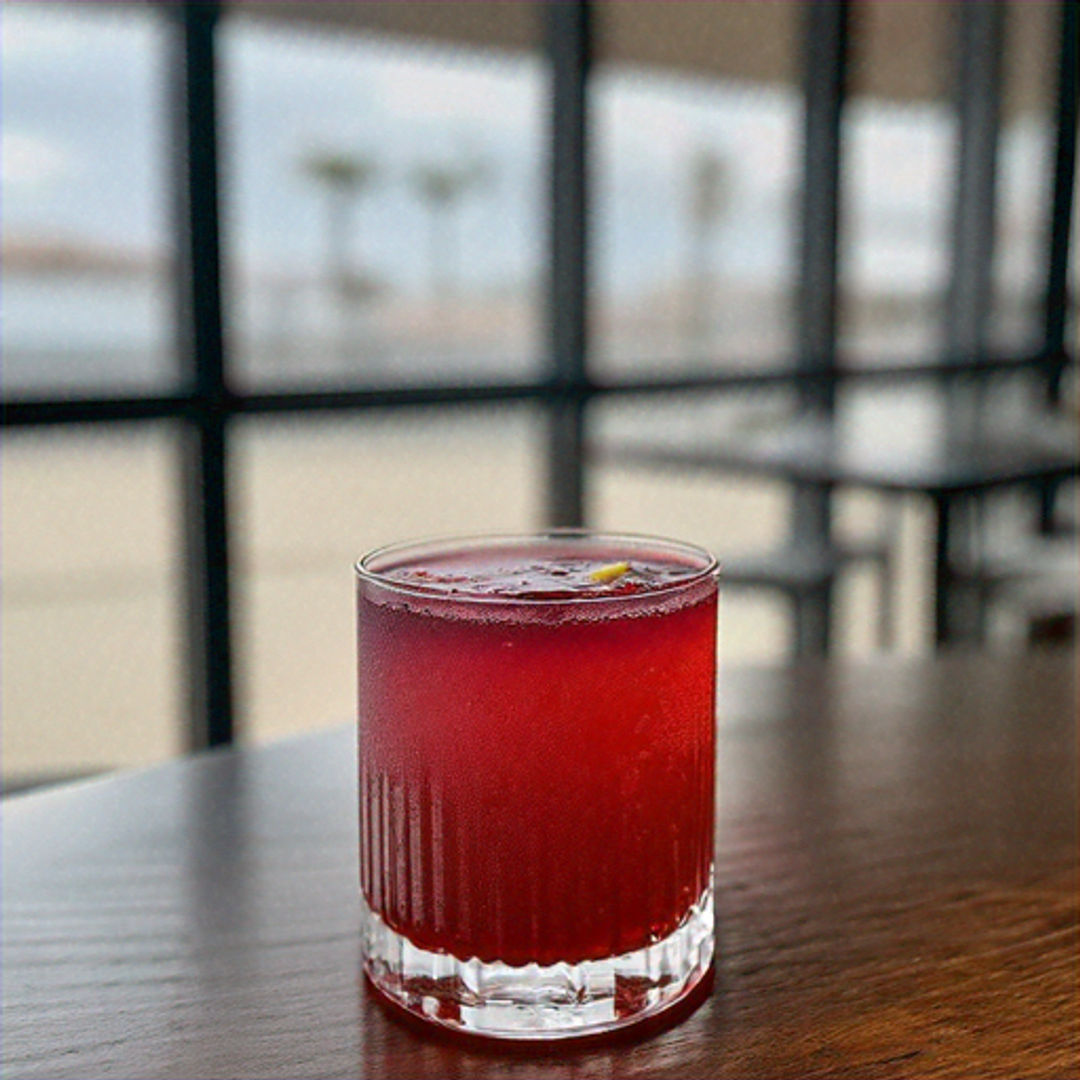 Crimson Elixir, Vibrant, sweet, tart, herbal cocktail with deep red hues