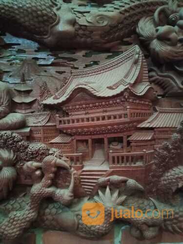 Relief kayu jati Buddha dan naga di Kota Tangerang Selatan, Banten ...
